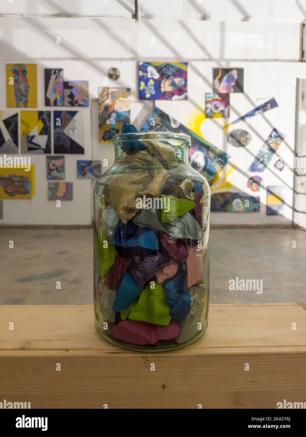 The vertical view of a jar filled with colorful body parts at the ...