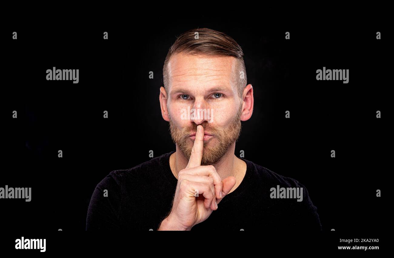 Black man showing silence gesture hi-res stock photography and images ...