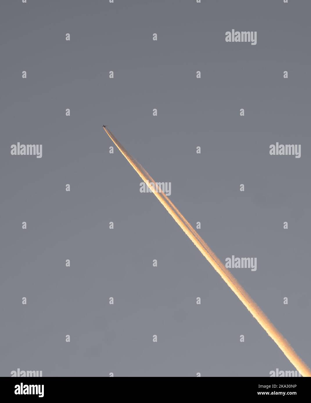 A vertical shot of airplane trails in the sky Stock Photo - Alamy