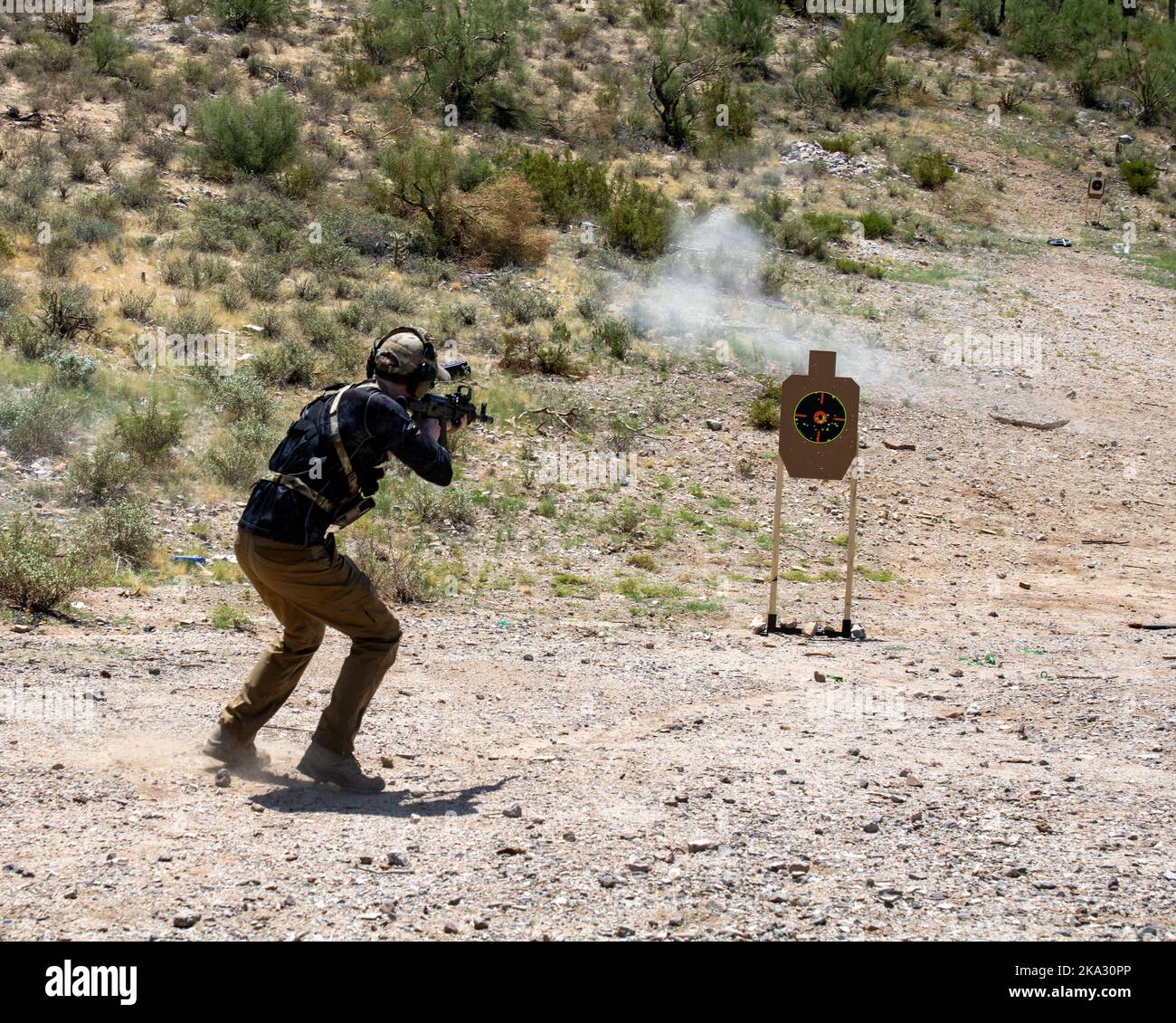 A caucasian man shooting a AR15 Pistol using 5.56mm ammo in Arizona ...