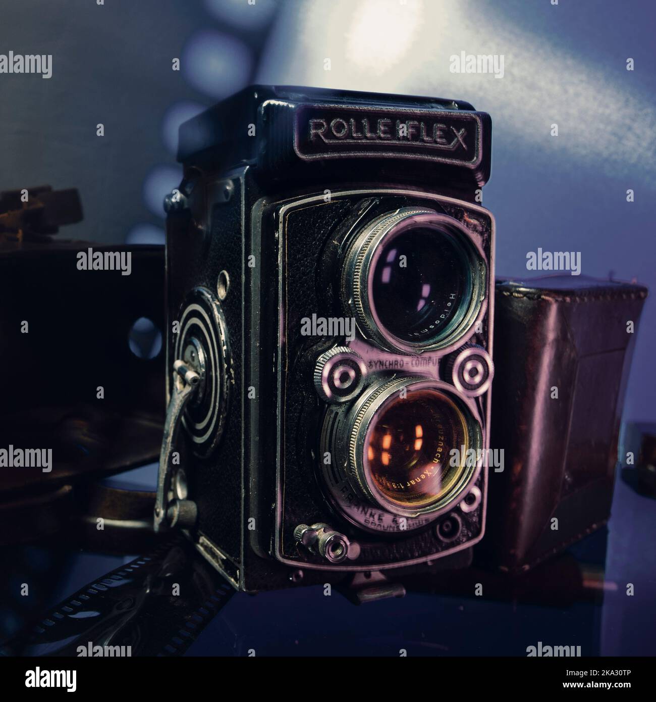 An old vintage Rolleiflex camera on the table on blur cinematic ...