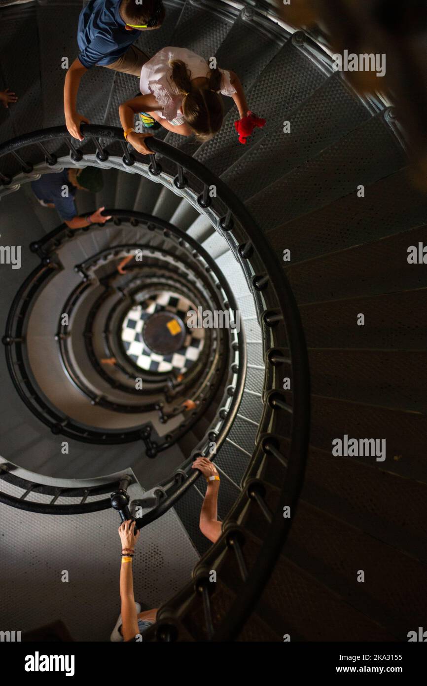 The vertical top view of kids running up the stairs of Ponce Inlet ...