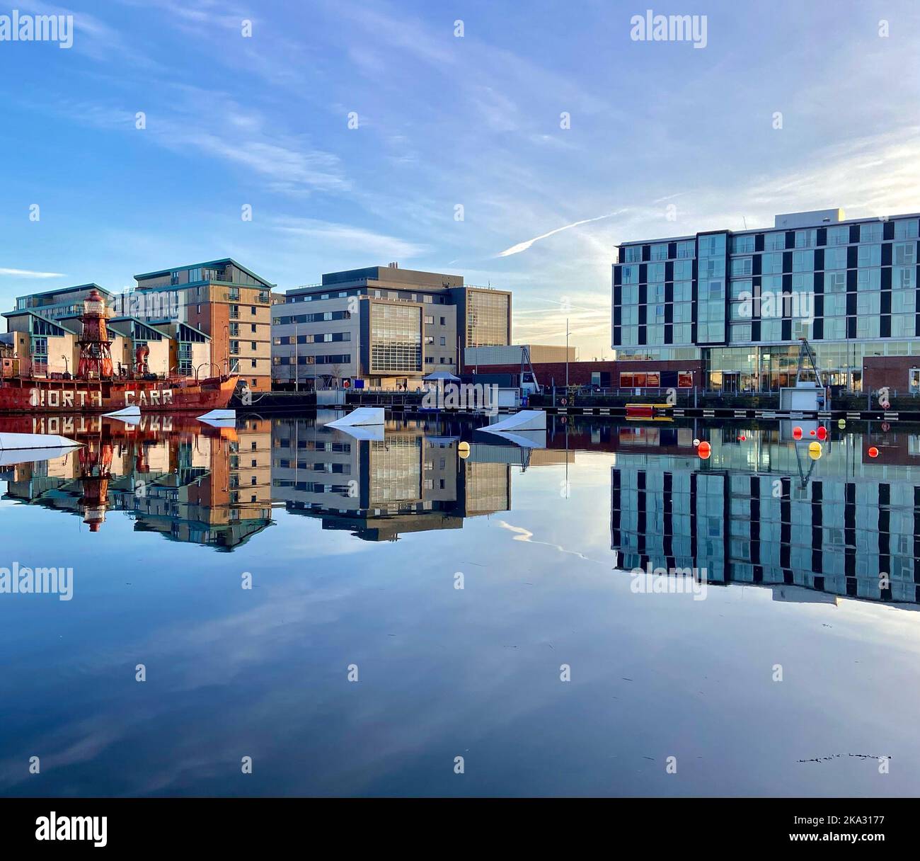 A breathtaking view of Dundee Harbor and its reflection in the water on ...