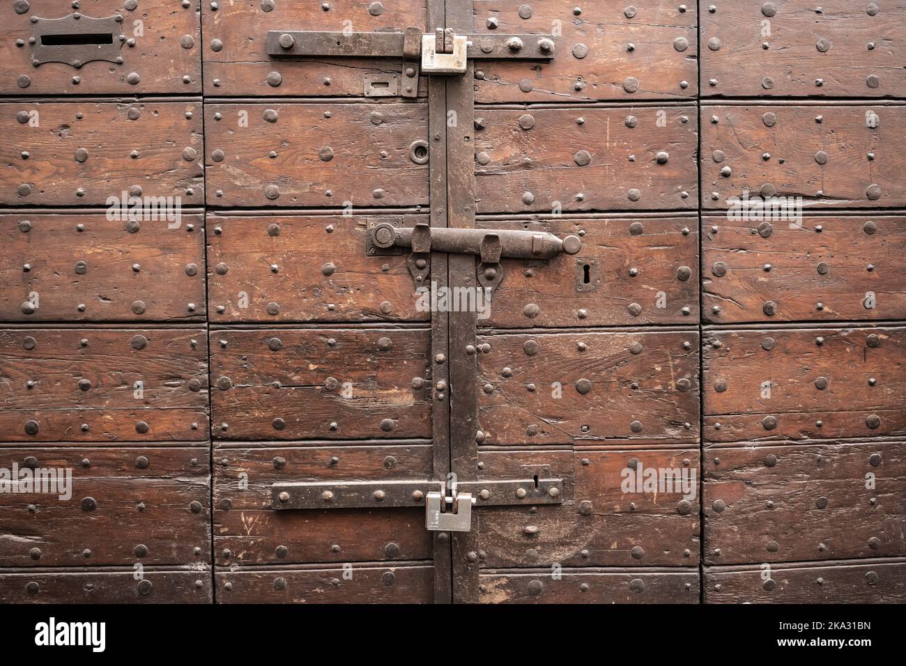 A closeup of a wooden door with metal locks in Rome, Italy Stock Photo ...