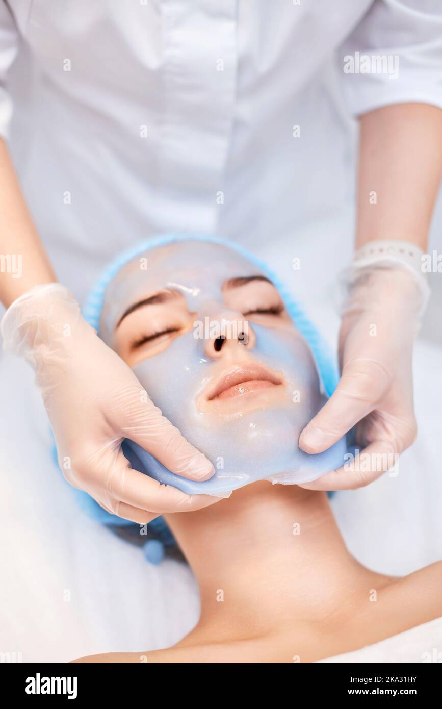 beautician removing mask from face of beautiful woman Stock Photo - Alamy