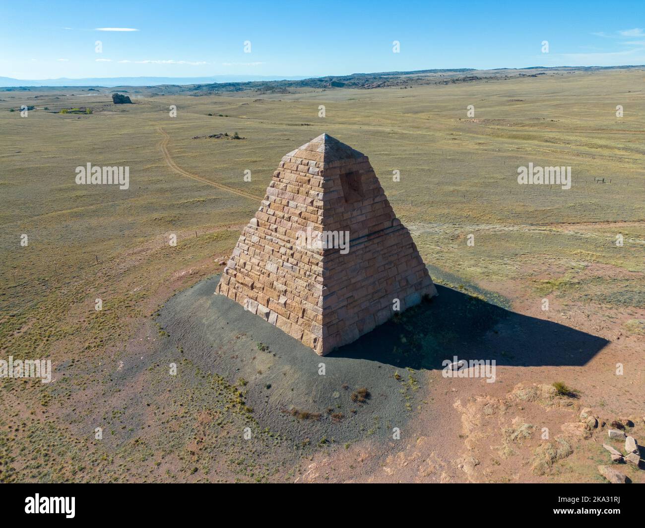 A top view of Ames monument in the middle of the field under blue sky ...