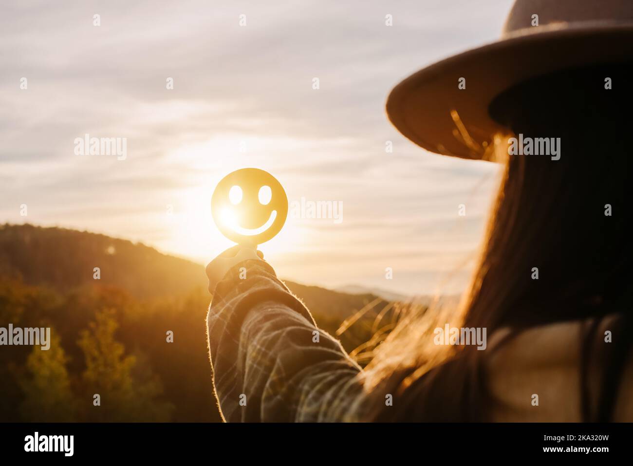 Close up of young woman holding happy smile face on background epic ...