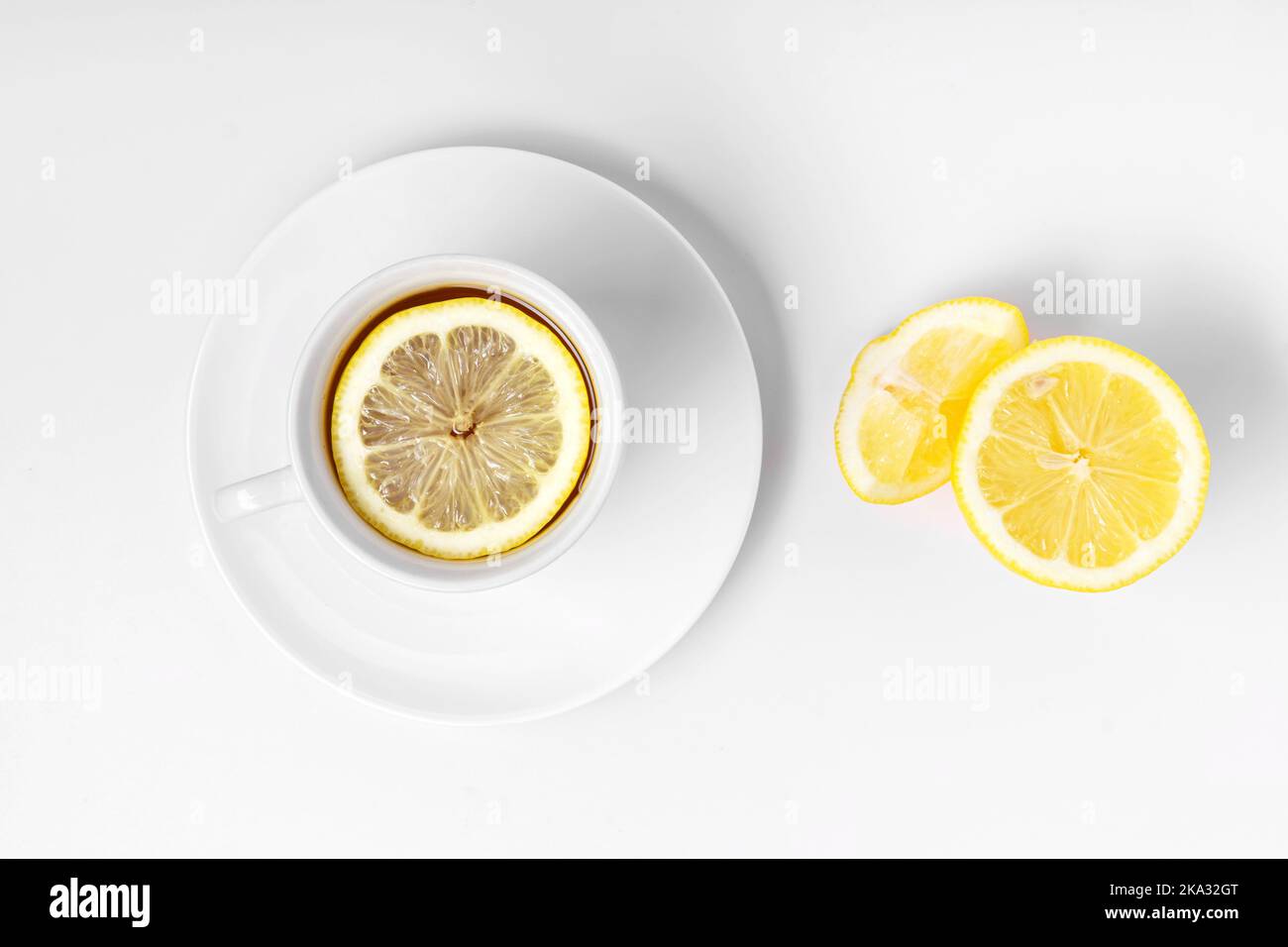 A cup of fresh tea with lemon and ginger. White background, isolated ...