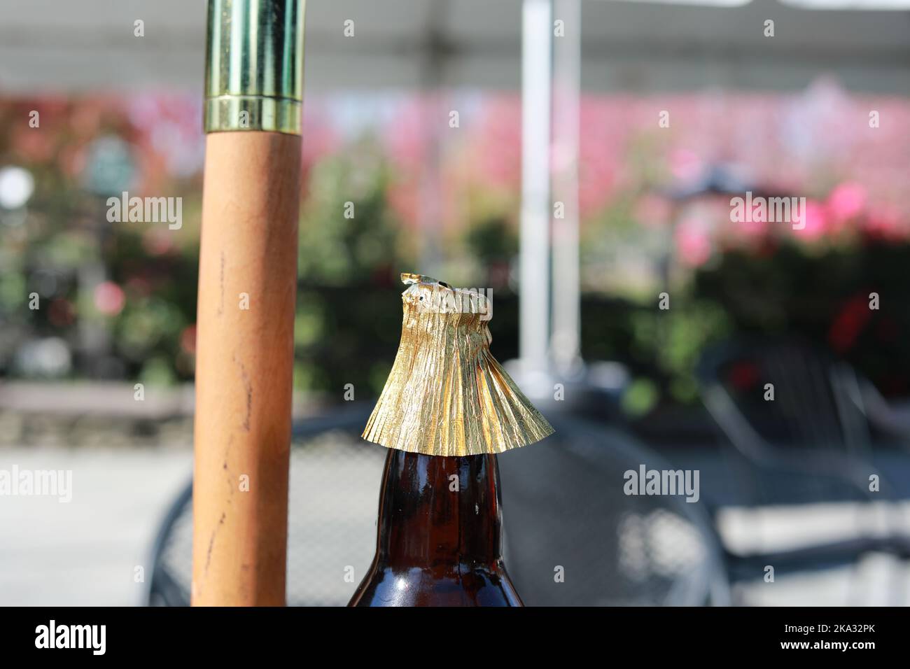 A closeup of a gold foil wrapper over a beer bottle in sunlight Stock ...