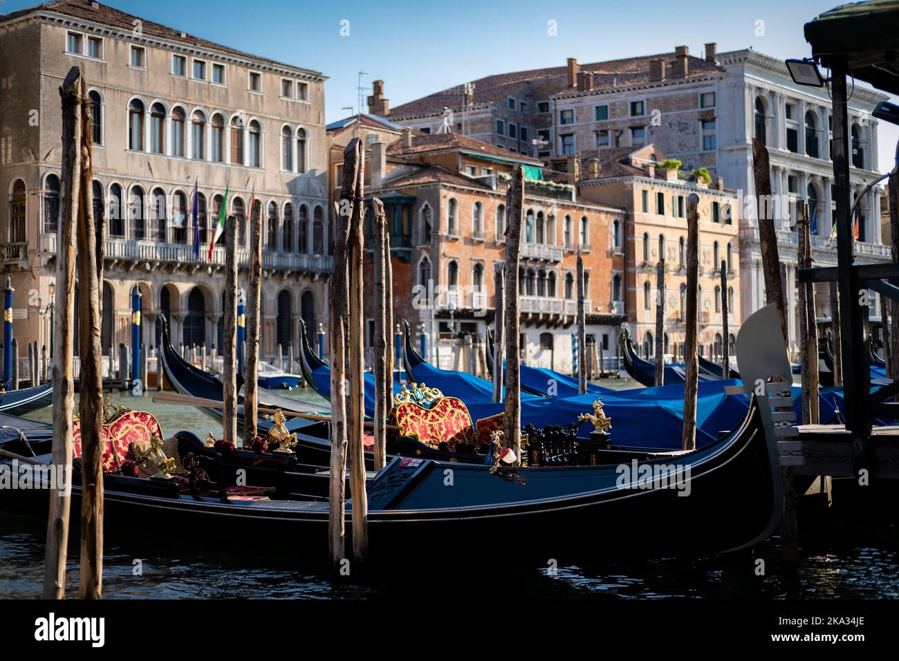Several boats docked in the channels of Venice against the medieval ...