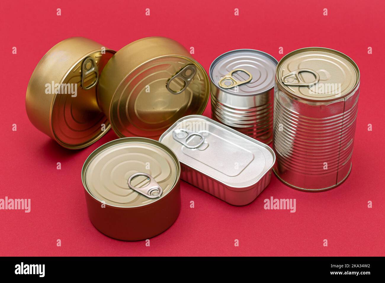 A Group of Stacked Tin Cans with Blank Edges on Red Background. Canned ...