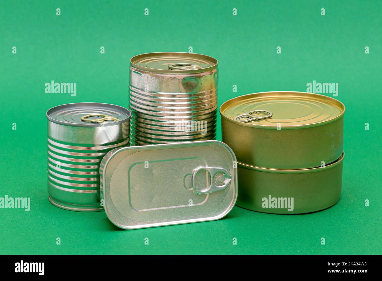 A Group of Stacked Tin Cans with Blank Edges on Green Background ...