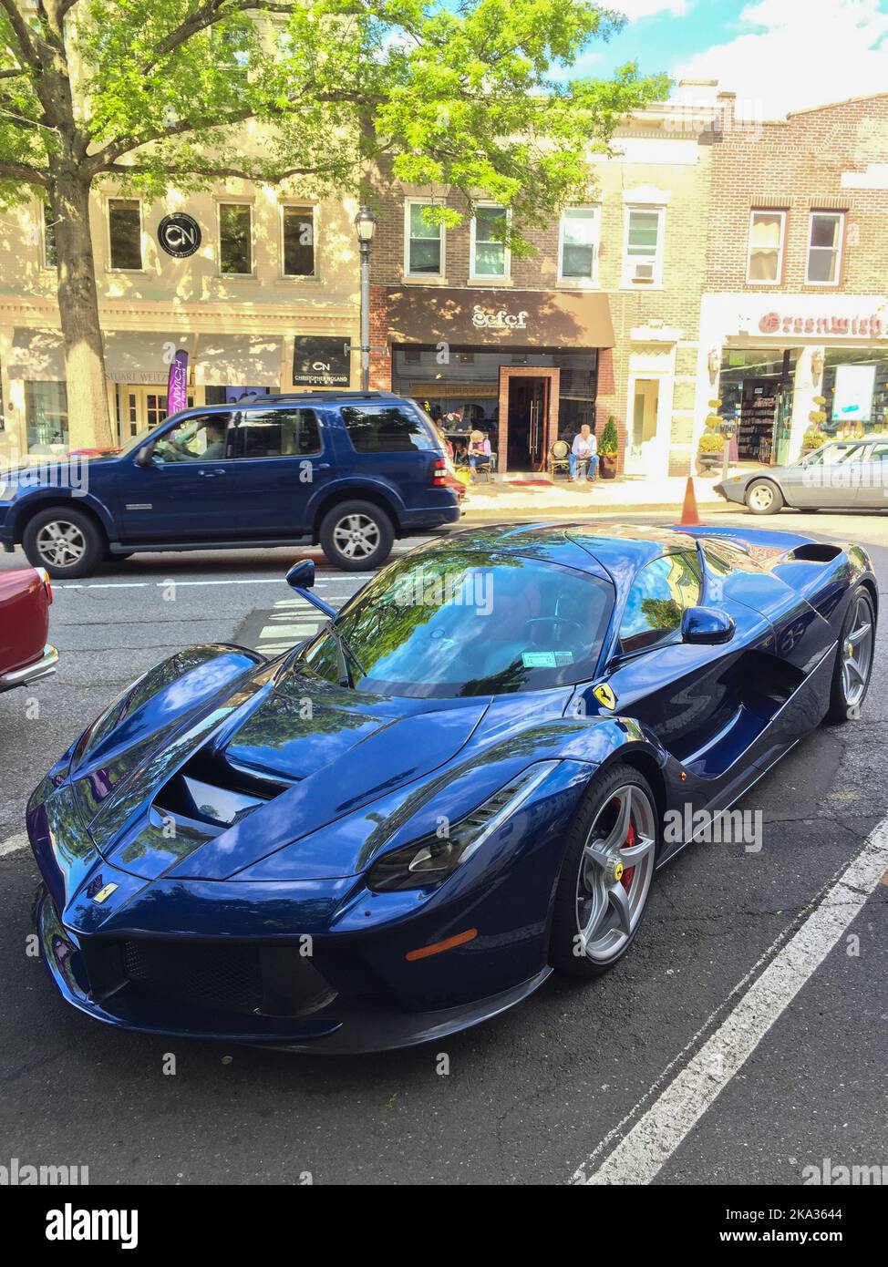 A blue Ferrari in Greenwich CT with hybrid engine parked on the street ...