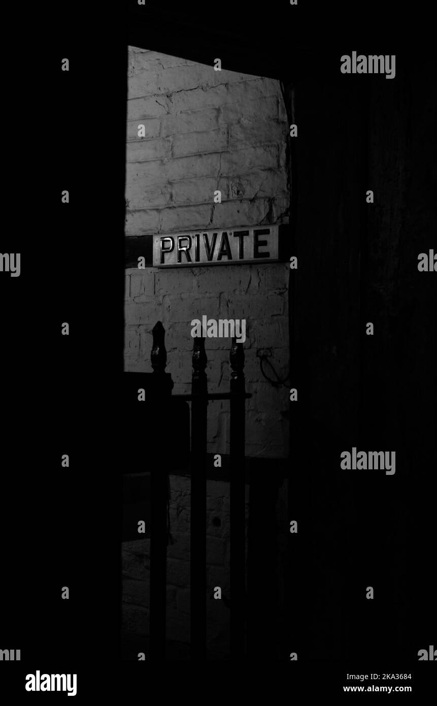 A vertical shot of a building entrance with a "PRIVATE" tablet shot in ...