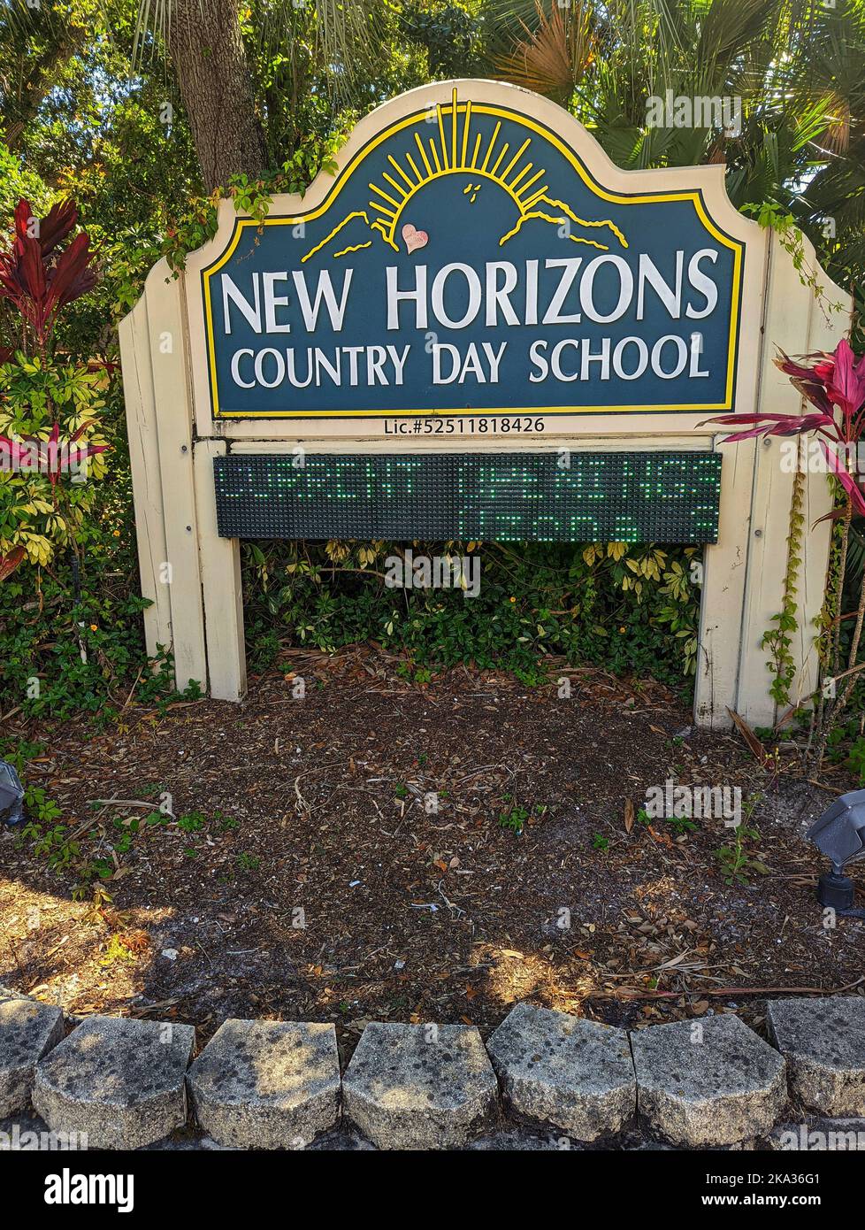 A vertical shot of the New horizons day school sign for young children ...