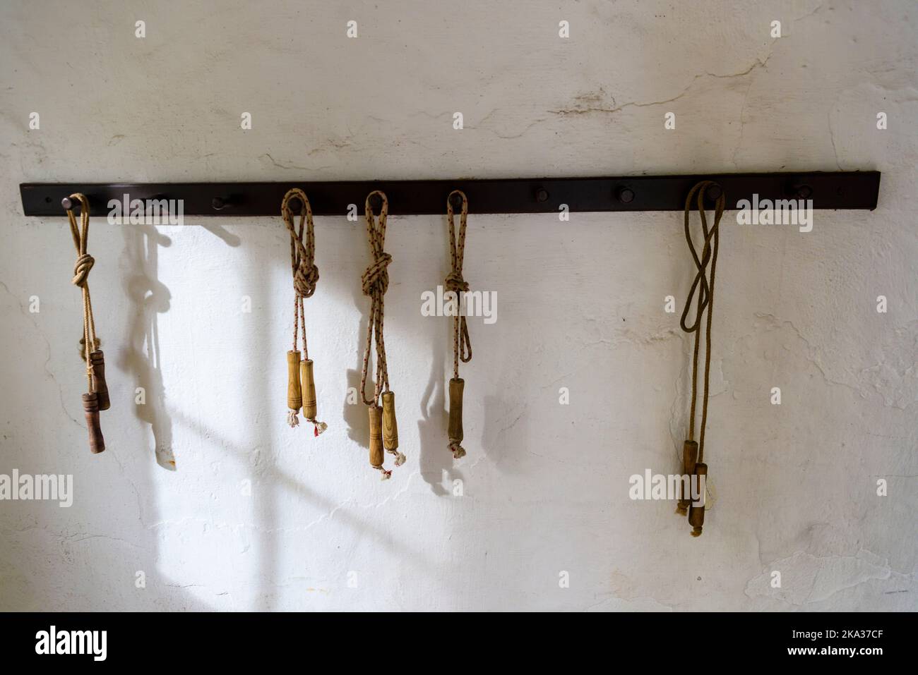 Old fashioned skipping ropes hanging from pegs in the entrance of an ...