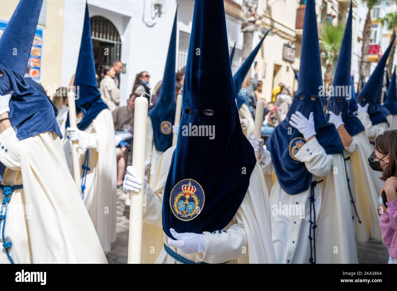 People wearing traditional capirote conical pointed hats in an easter ...
