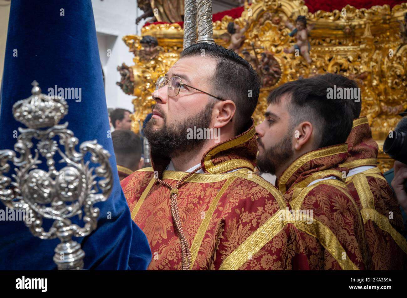 People wearing brightly coloured traditional clothes take part in an ...