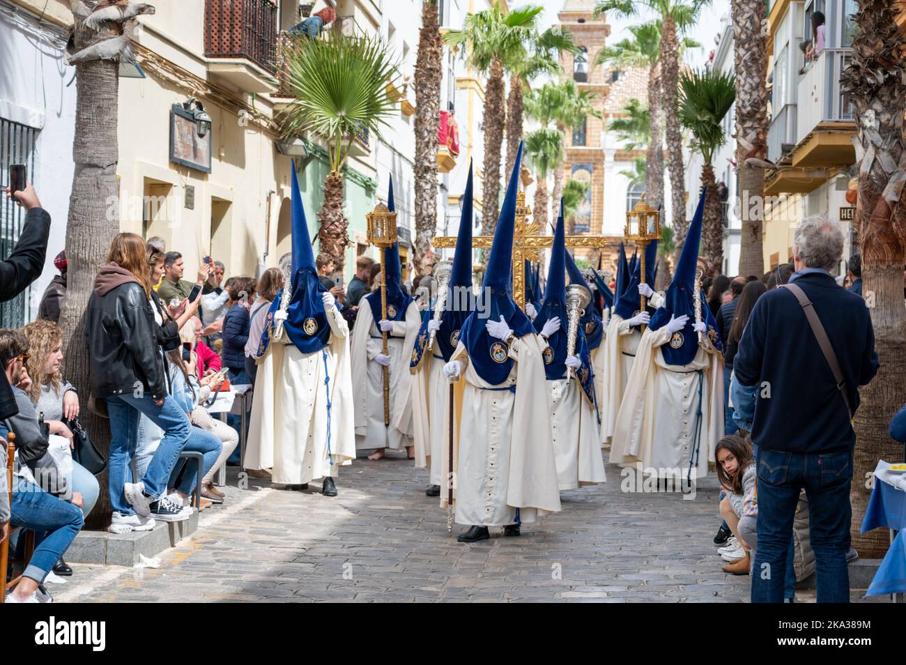 People wearing traditional capirote conical pointed hats in an easter ...
