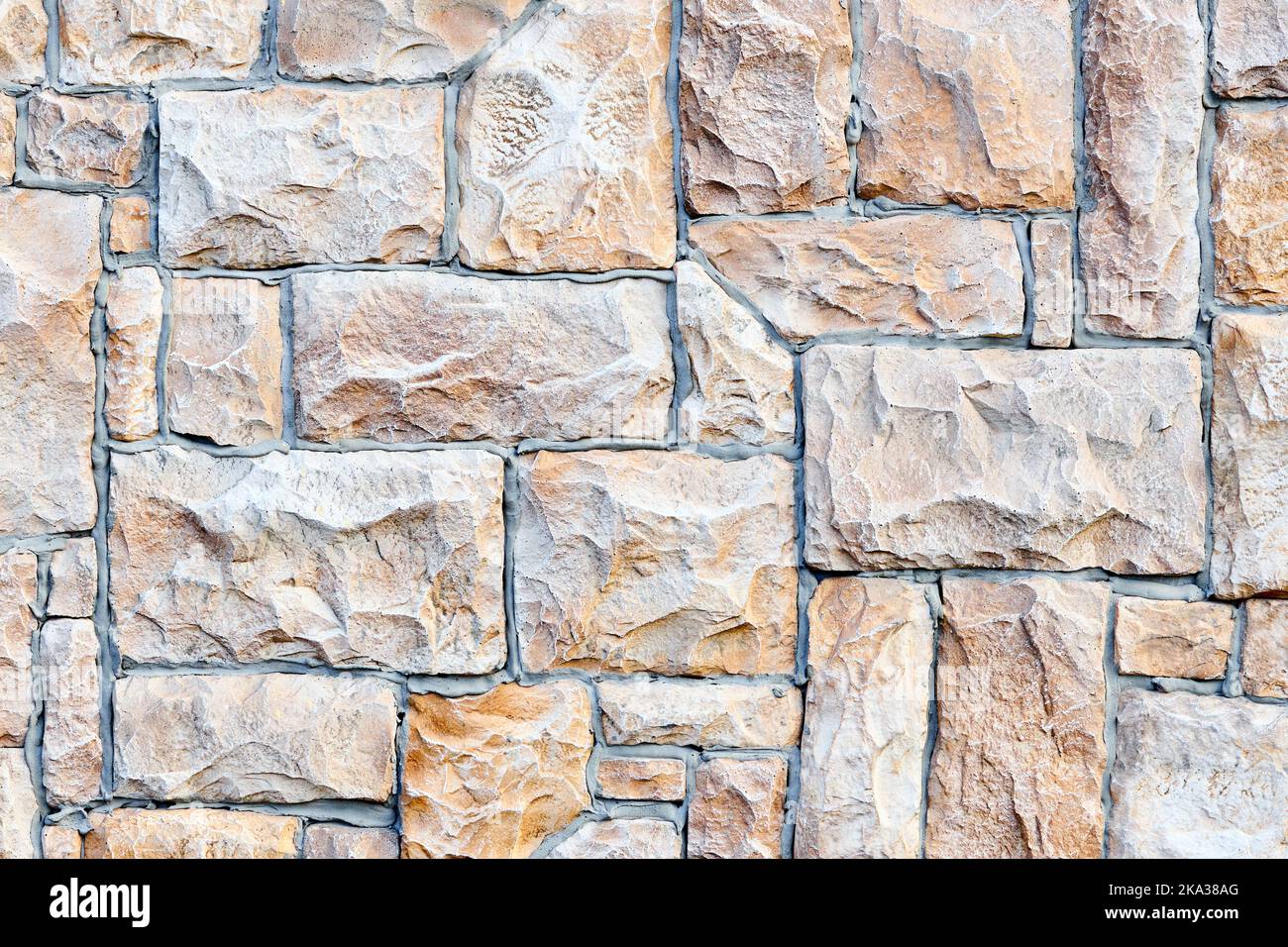 Cobble brown stone siding tile wall abstract background. House exterior ...