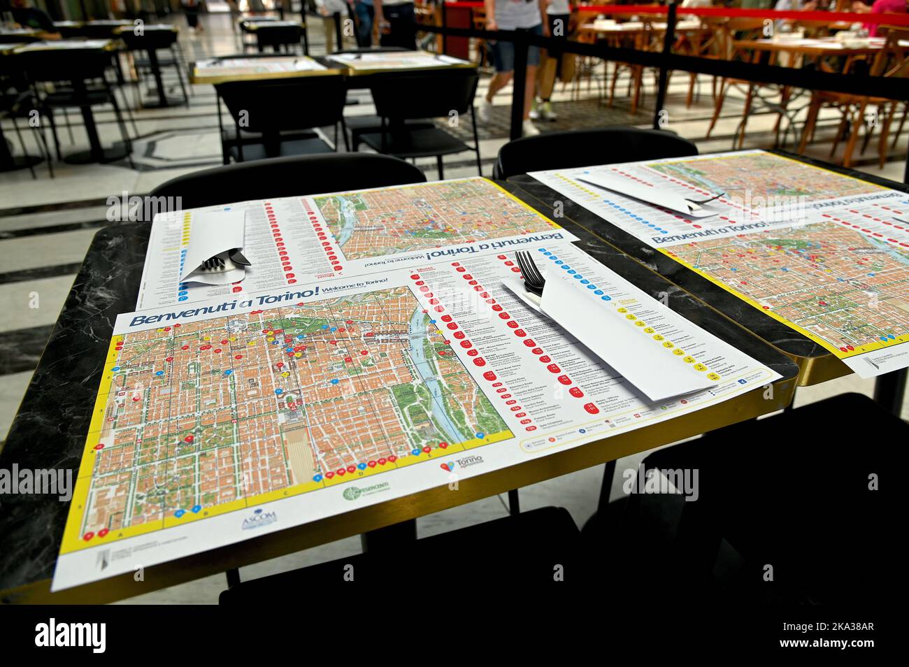 A Turin claim and downtown map on restaurant terrace tables, paper ...