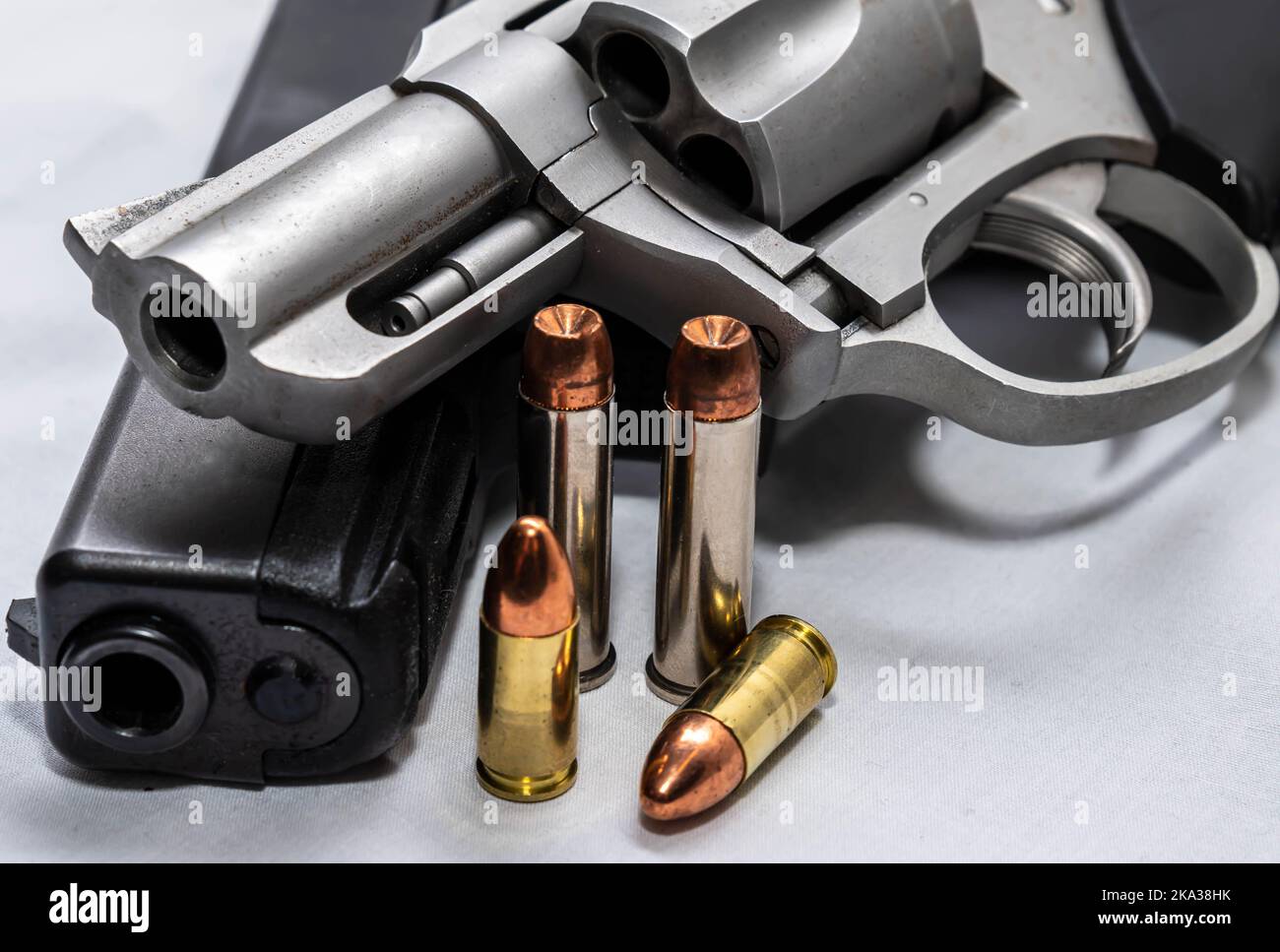 Two handguns, a black 9mm pistol and a stainless 357 magnum with two ...