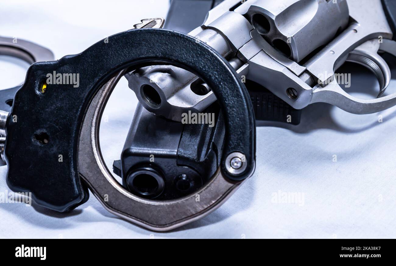 Two handguns, a black 9mm pistol and a stainless 357 magnum with a half ...