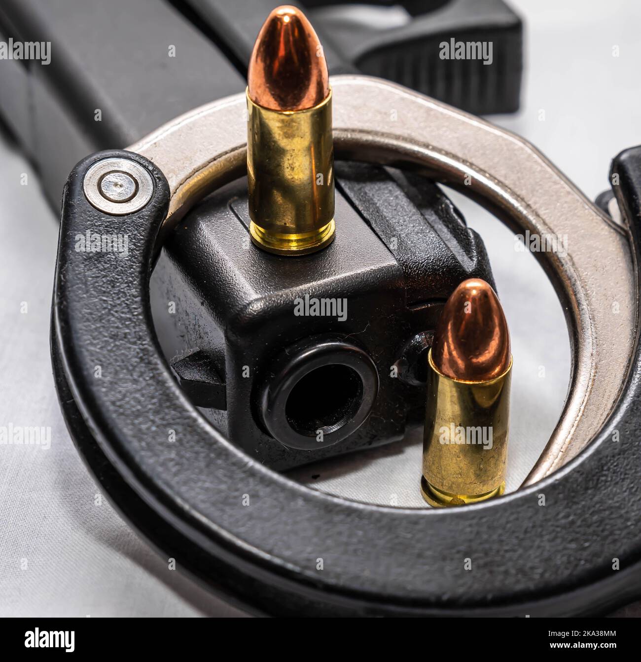 Two 9mm full metal jacket bullets with a black 9mm pistol and a half of ... Two 9mm full metal jacket bullets with a black 9mm pistol and a half of ...