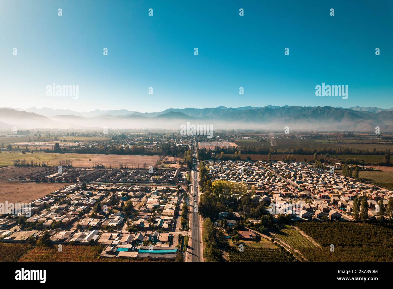 An aerial shot of a road in the middle of a valley town Stock Photo - Alamy