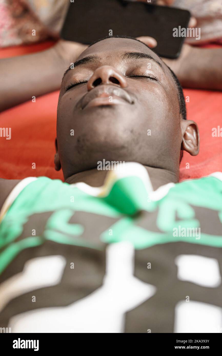 African American man sleeping on bed Stock Photo - Alamy