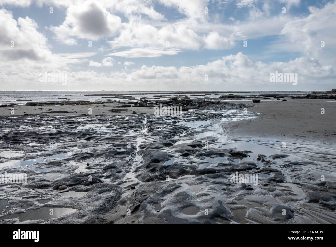 rock pools on a beautiful deserted sandy beach in Lyme Regis Dorset ...