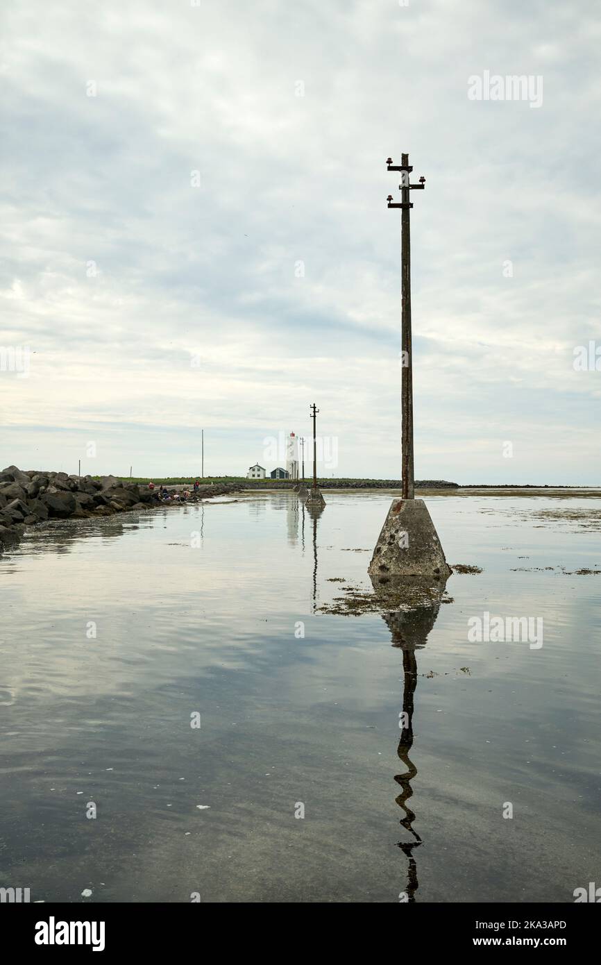 Utility pole near shore of sea Stock Photo - Alamy