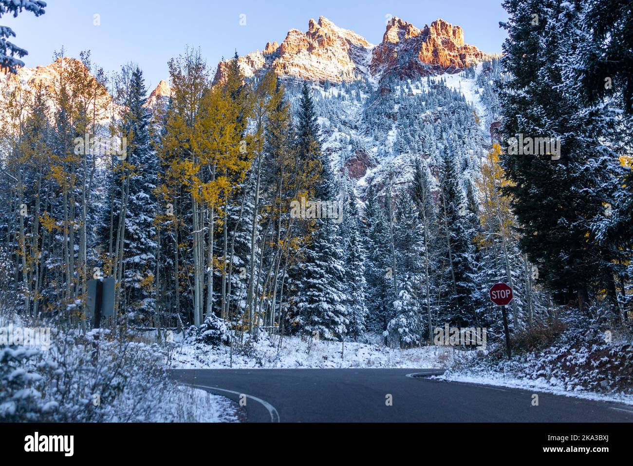 Maroon Bells Creek empty road in Aspen, Colorado Rocky Mountains covered in snow after late fall ...