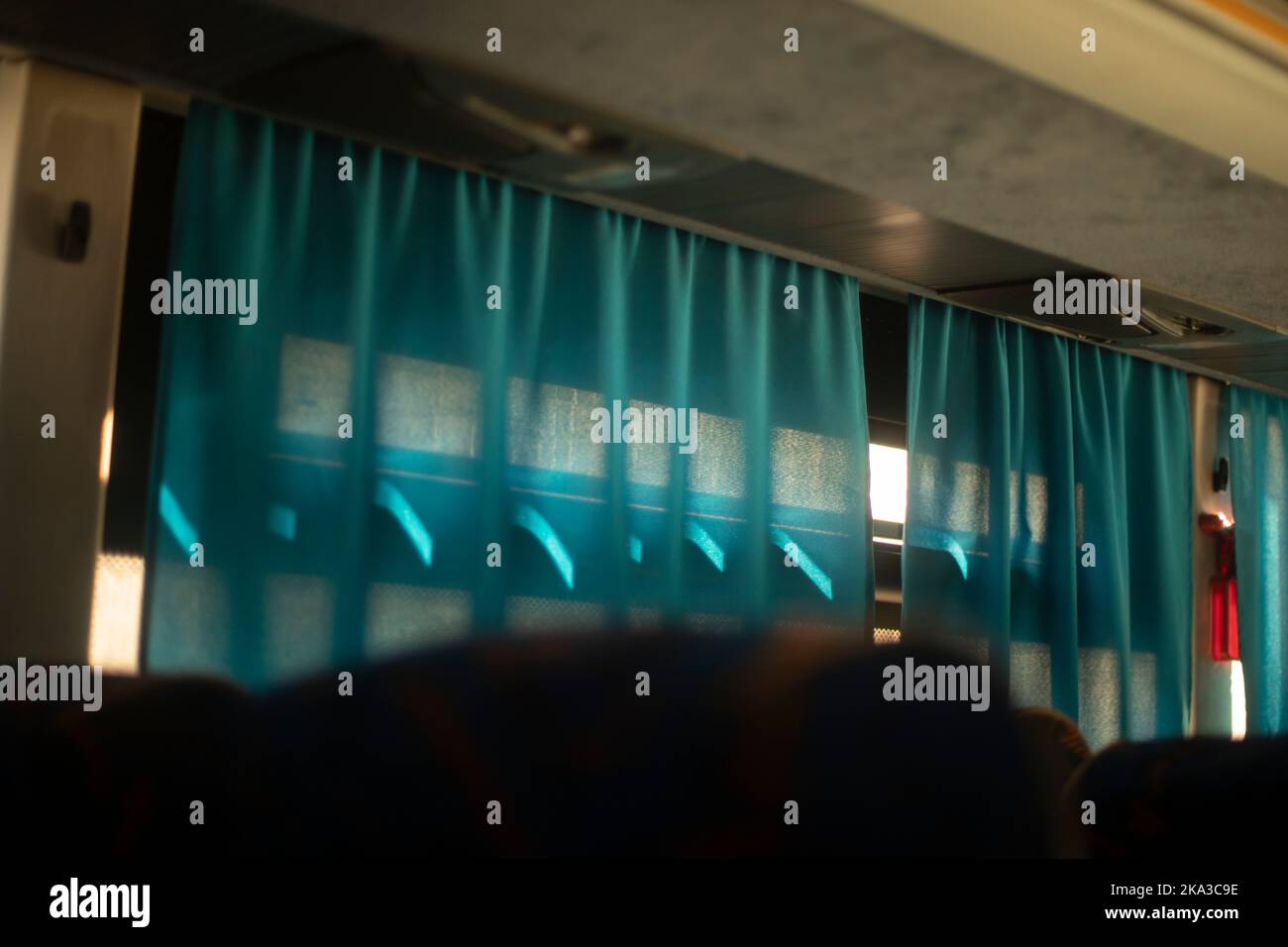 Curtains on window in bus. Details of interior of bus. Blue curtains on ...