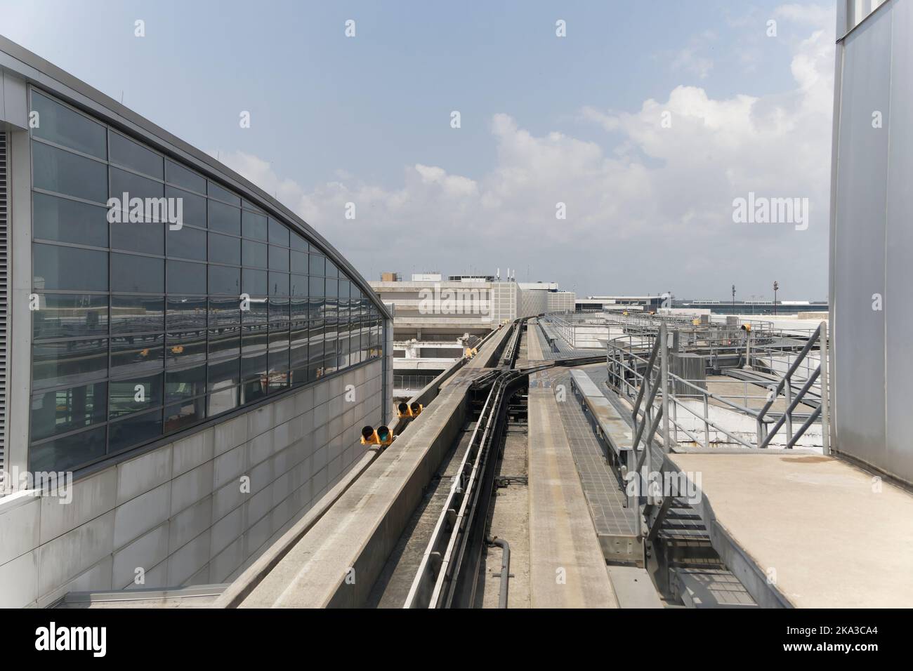 An outdoor AirTrain terminal on blue cloudy sky background Stock Photo ...