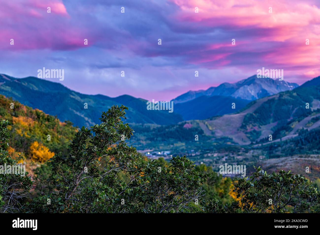 Pink purple sunset in Woody Creek in Aspen, Colorado with Rocky mountains of Buttermilk ski ...