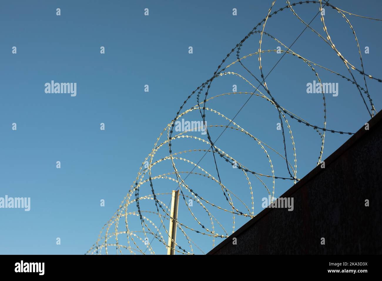 Barbed wire on fence. Private territory. High fence. Safety system ...