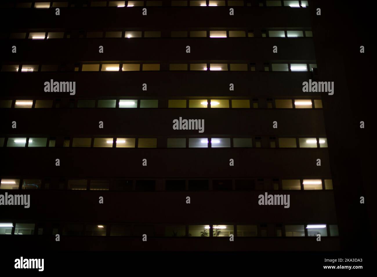 Windows in building at night. Unique architecture. Details of house ...