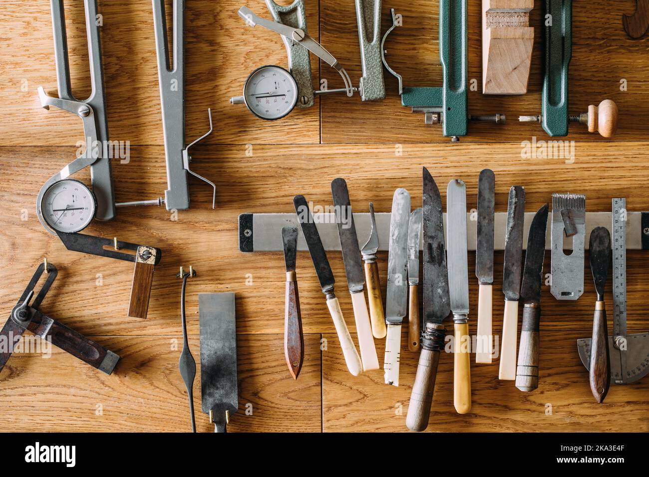 Top view of arranged in order assorted chisels and calipers and precise ...