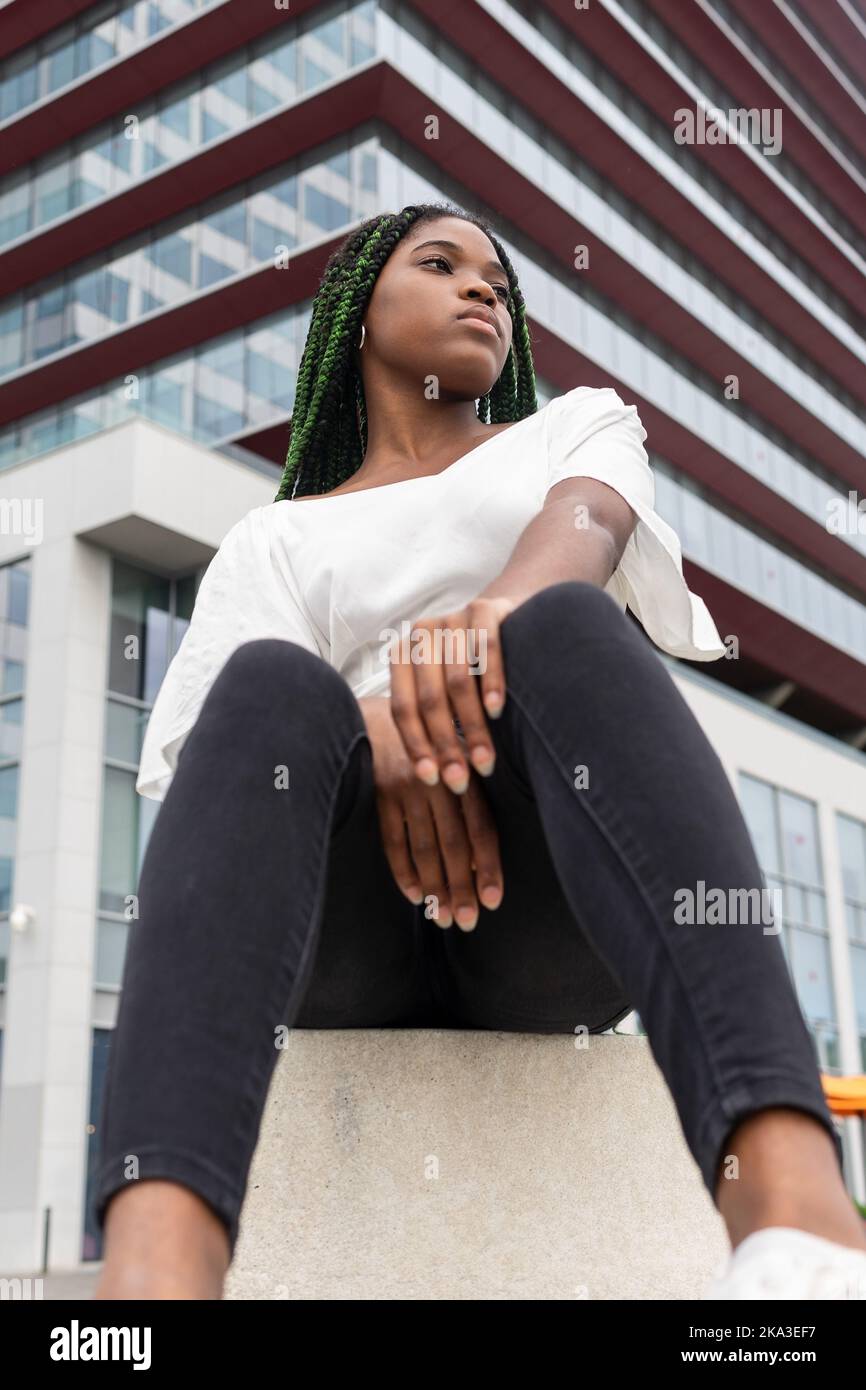 From below of stylish young African American female in casual outfit ...