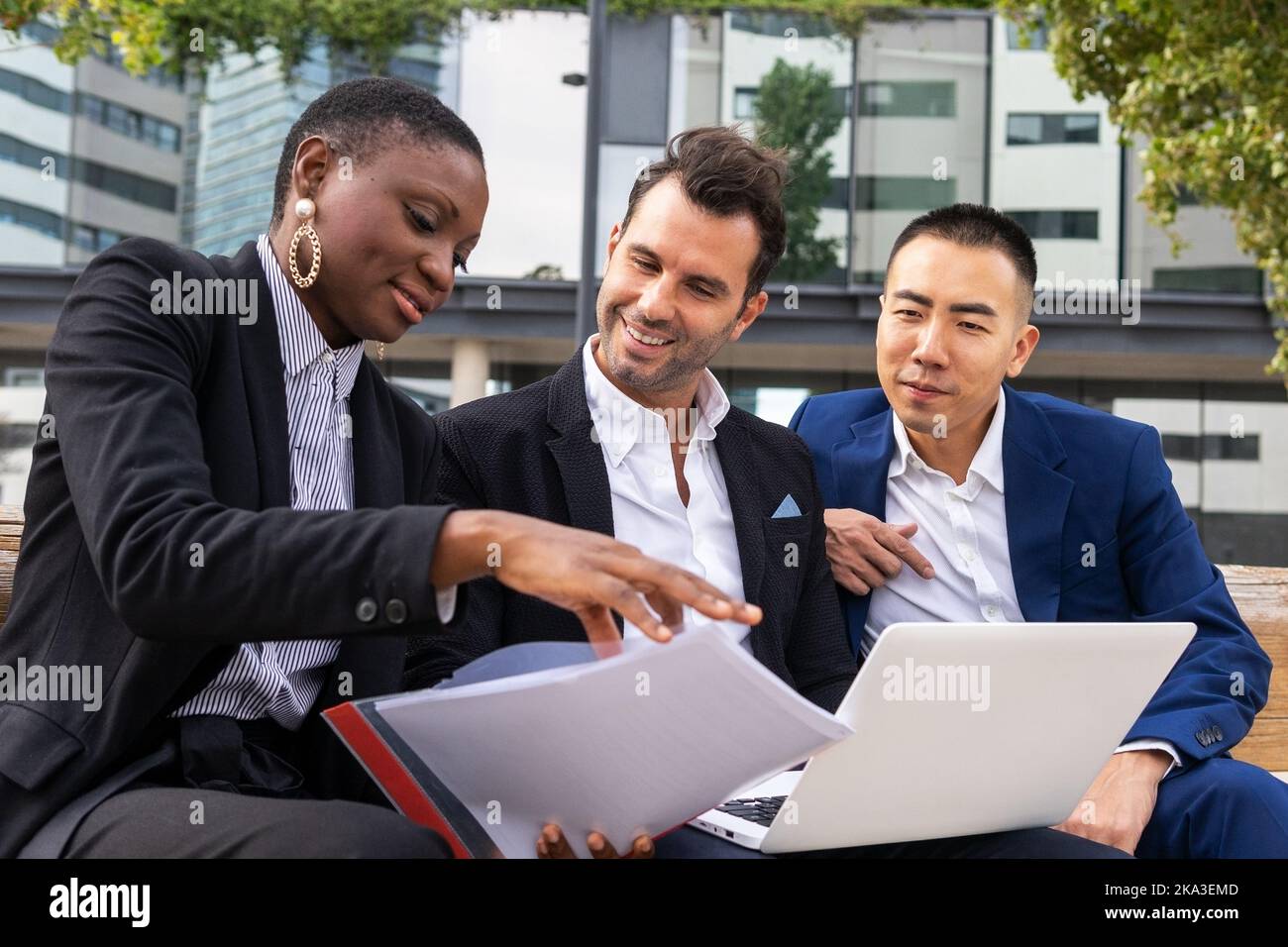 Group of multiracial coworkers in formal suits sitting on bench and ...