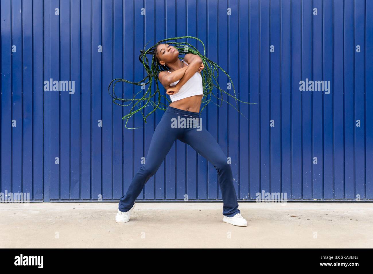 Full body cool African American female in denim and white top with long ...