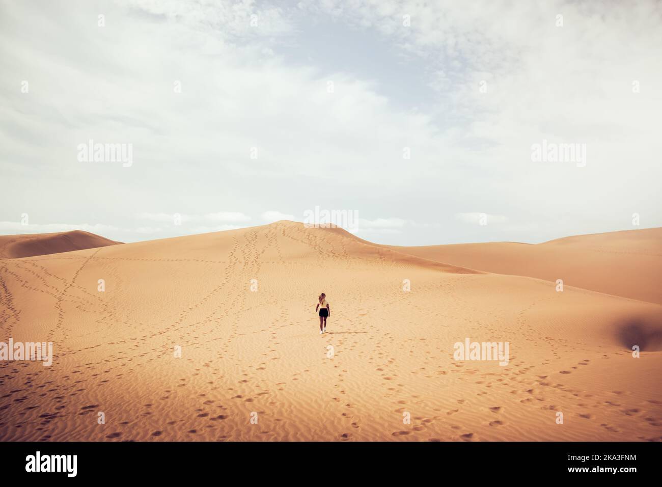 Back view of anonymous female tourist walking while exploring ...