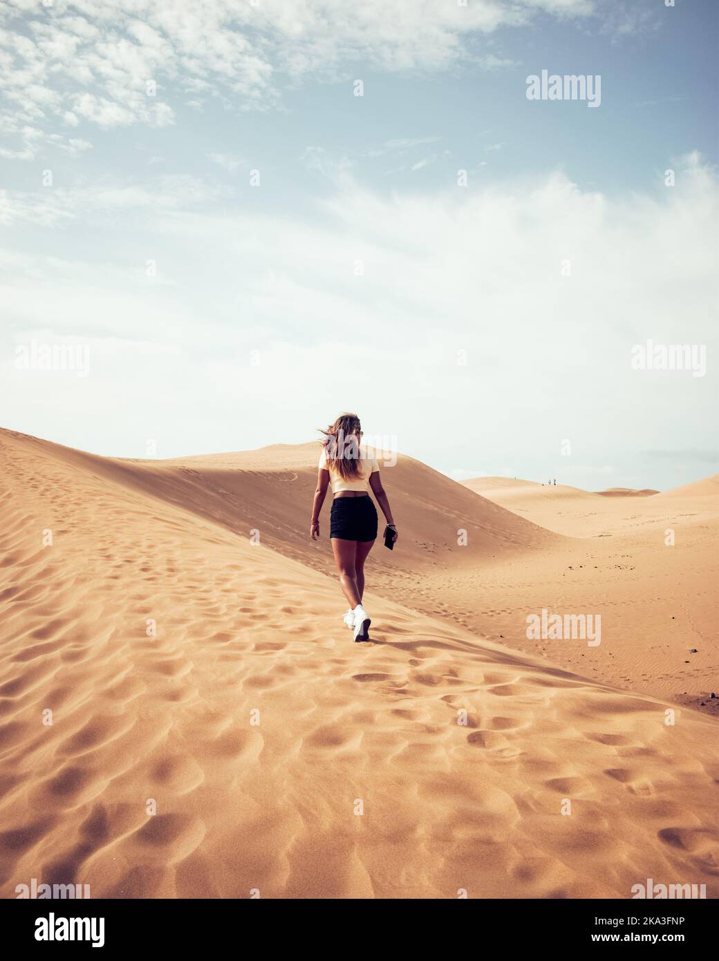 Back view of anonymous female tourist walking while exploring ...