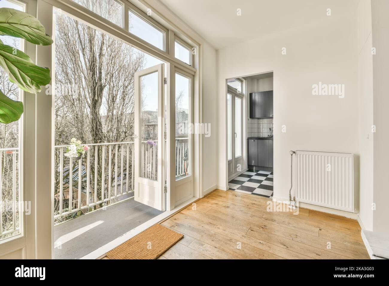 Interior of balcony with big glass windows in room with white walls ...