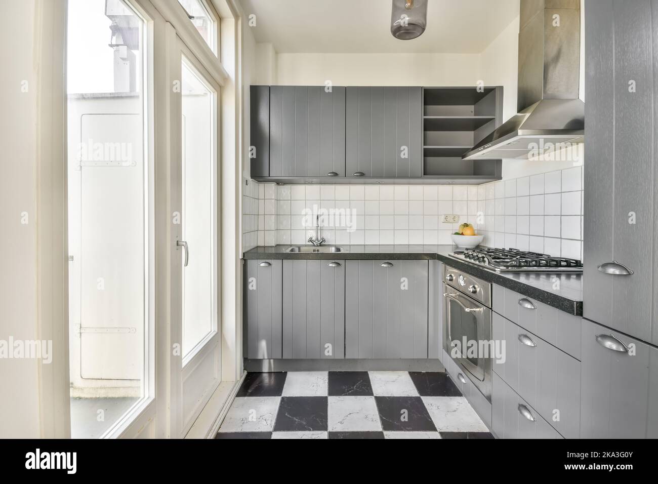 Minimalist interior of light kitchen with grey cabinets and modern ...