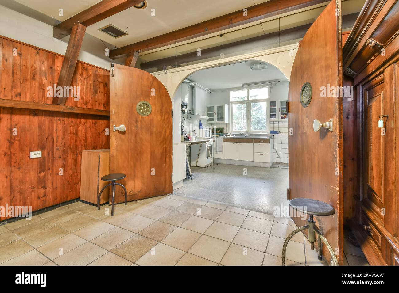Counter with white cupboards and modern built in appliances placed in ...