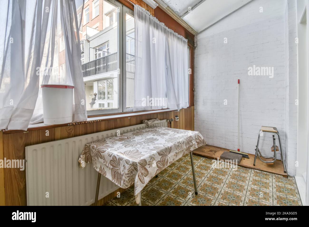 Interior of home with a table by a bright window Stock Photo - Alamy