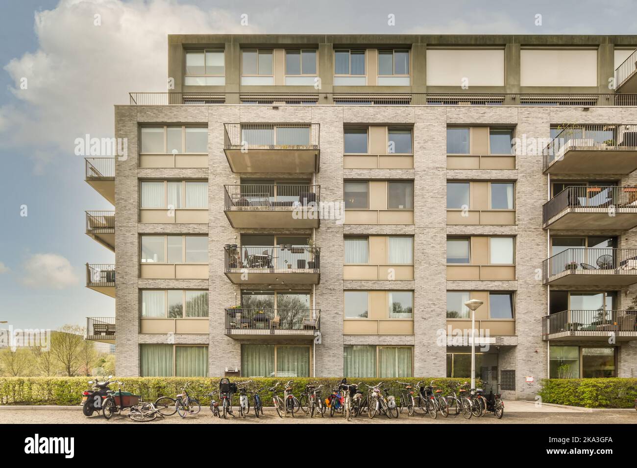 Front view of modern building under a sky with clouds Stock Photo - Alamy