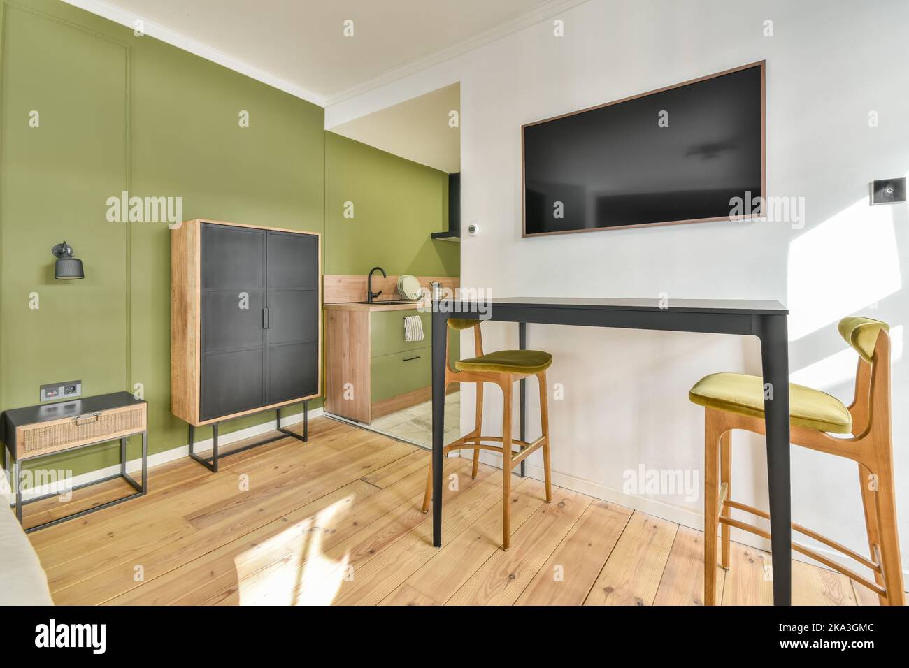 Chairs and table placed under television in living room with laminated ...